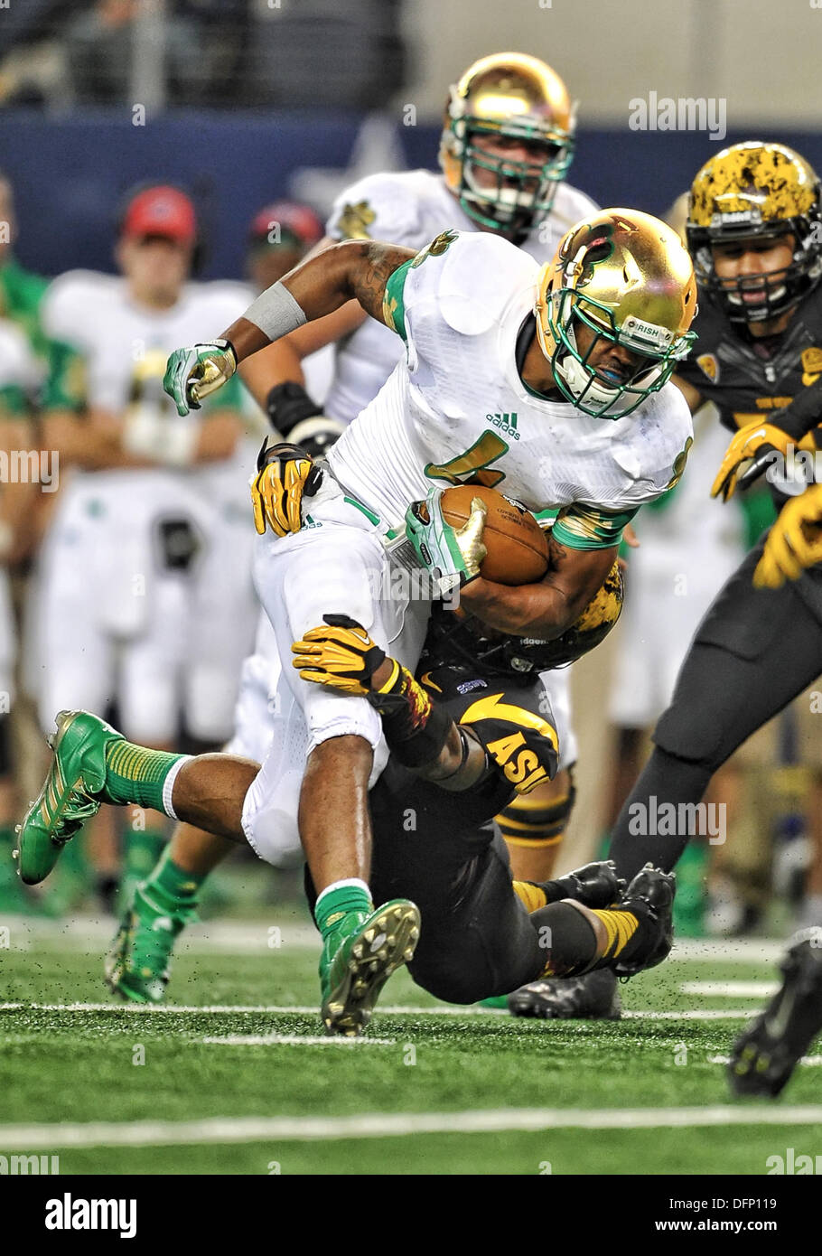 Notre Dame Fighting Irish running back George Atkinson III (4) carries the ball as he is tackled ...