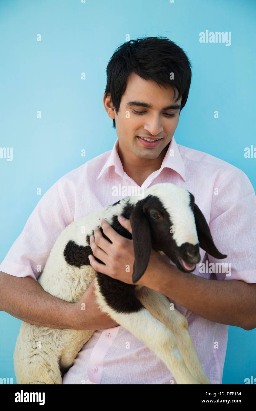 Young man holding lamb hi-res stock photography and images - Alamy