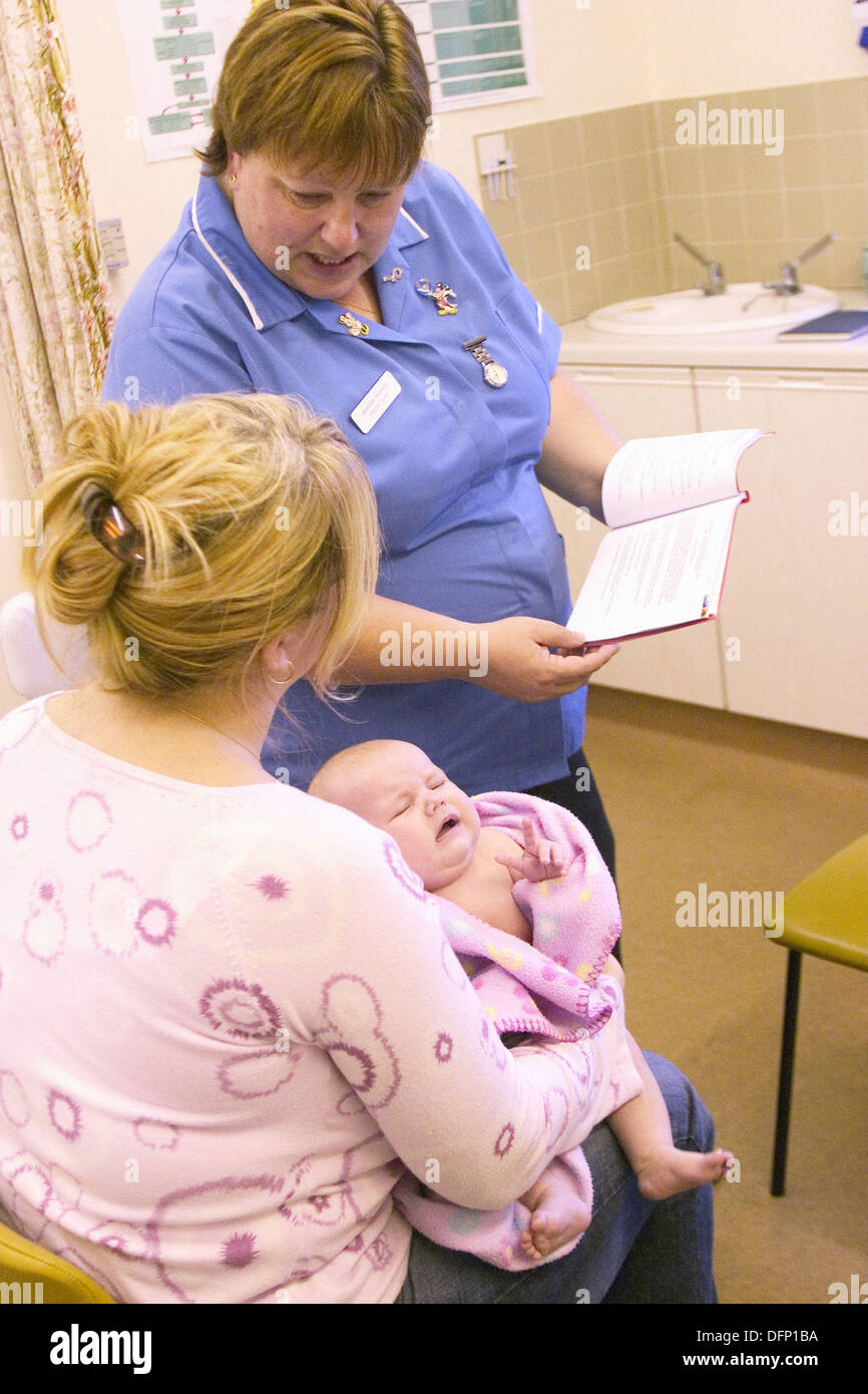 8 week old baby in mothers arms at doctors surgery, after having her ...