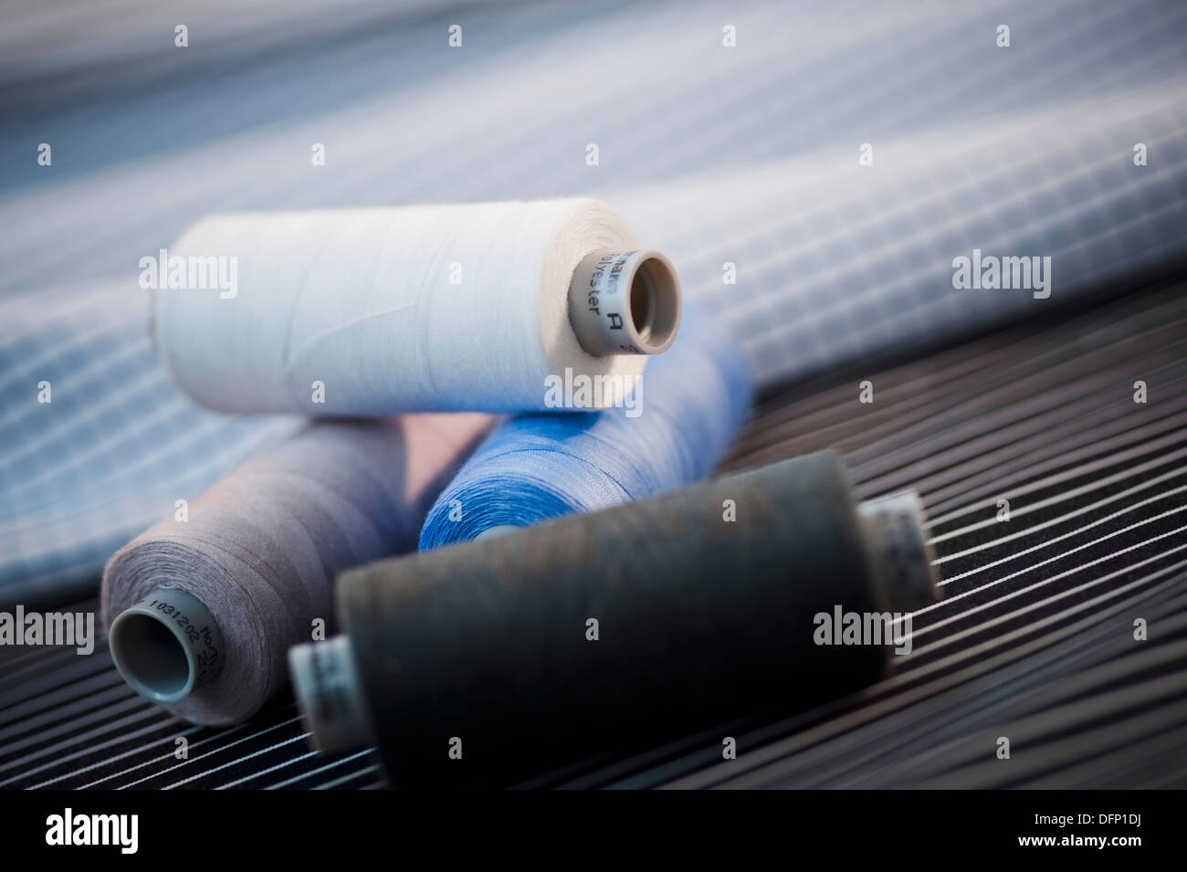 Close-up of spools of thread on a fabric Stock Photo - Alamy