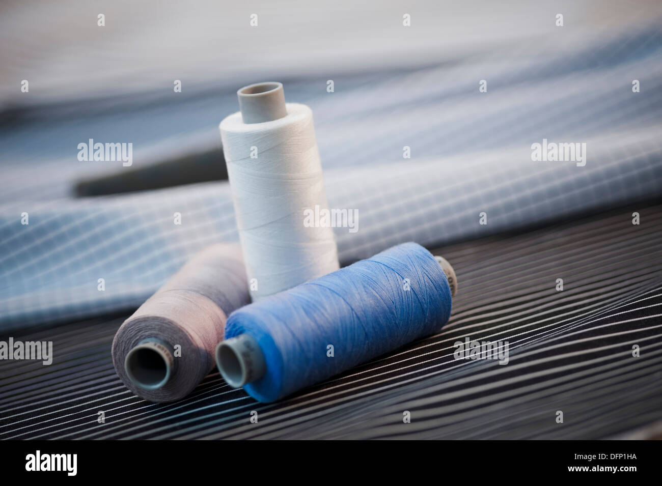 Close-up of spools of thread on a fabric Stock Photo - Alamy