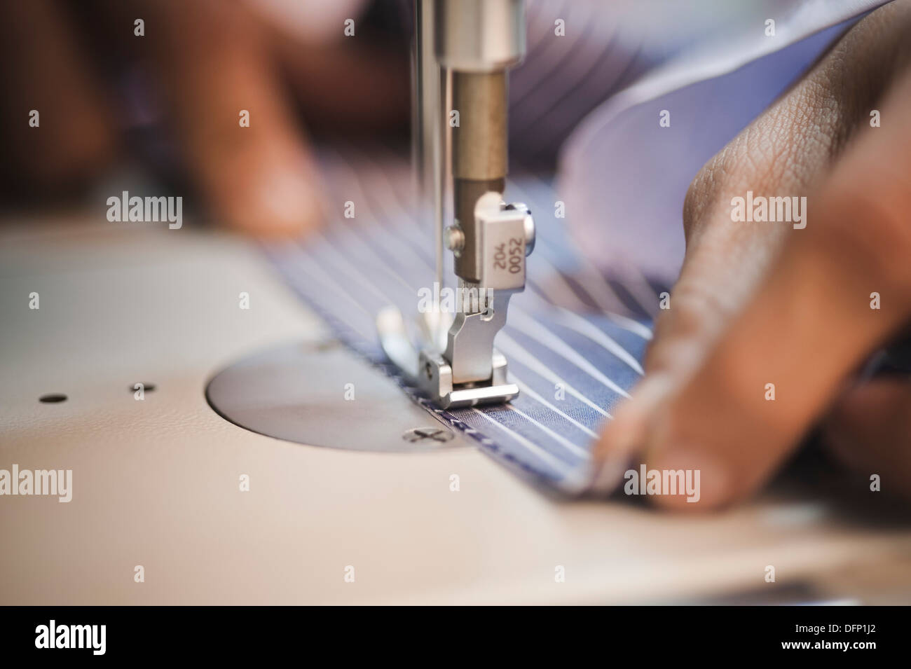 Cloth being stitched on the sewing machine Stock Photo - Alamy