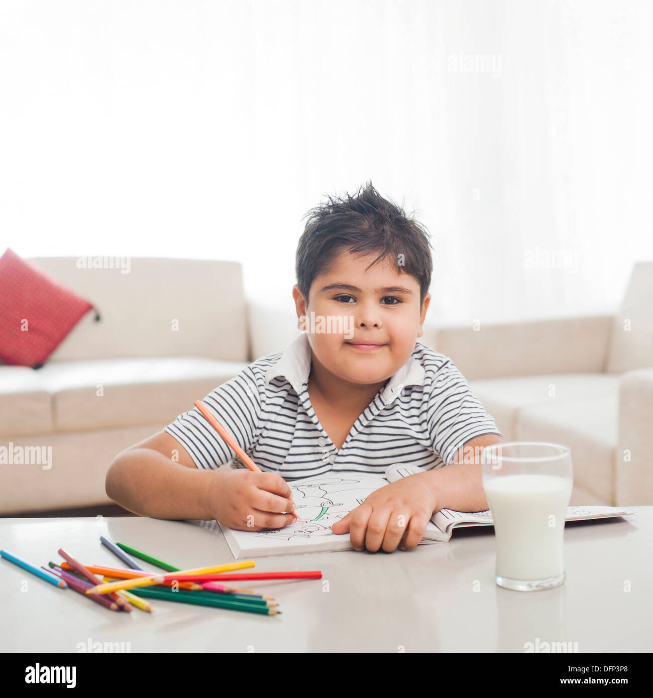 Boy coloring a picture book Stock Photo - Alamy