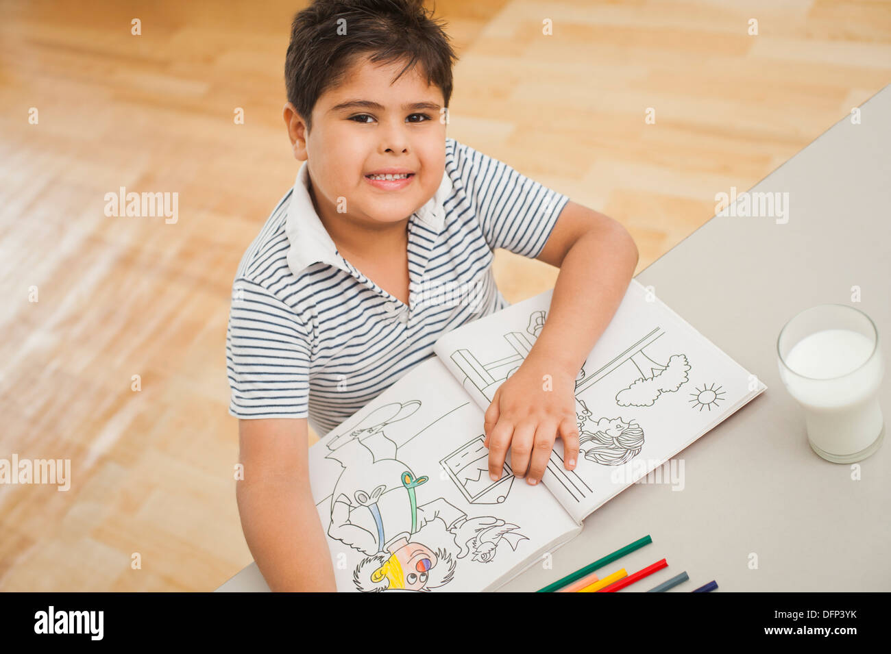 Boy coloring a picture book Stock Photo - Alamy