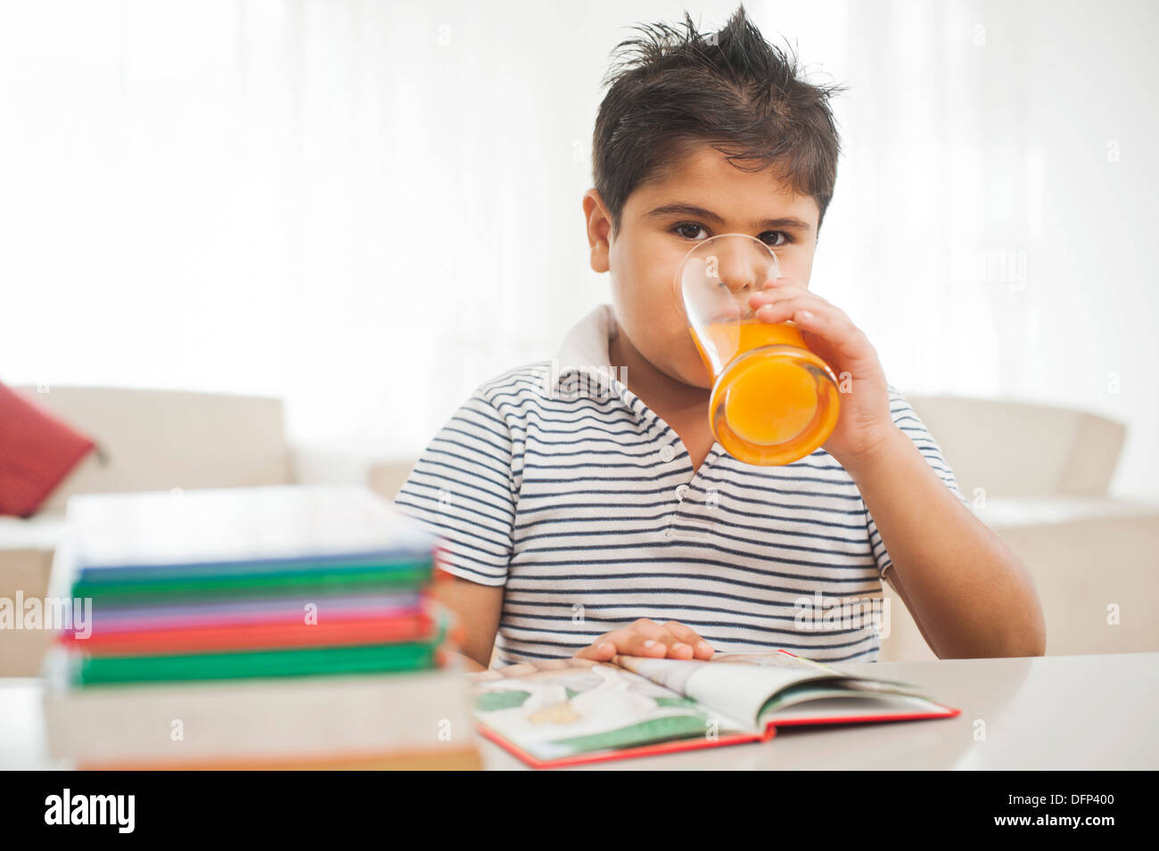 Boy drinking orange juice Stock Photo - Alamy