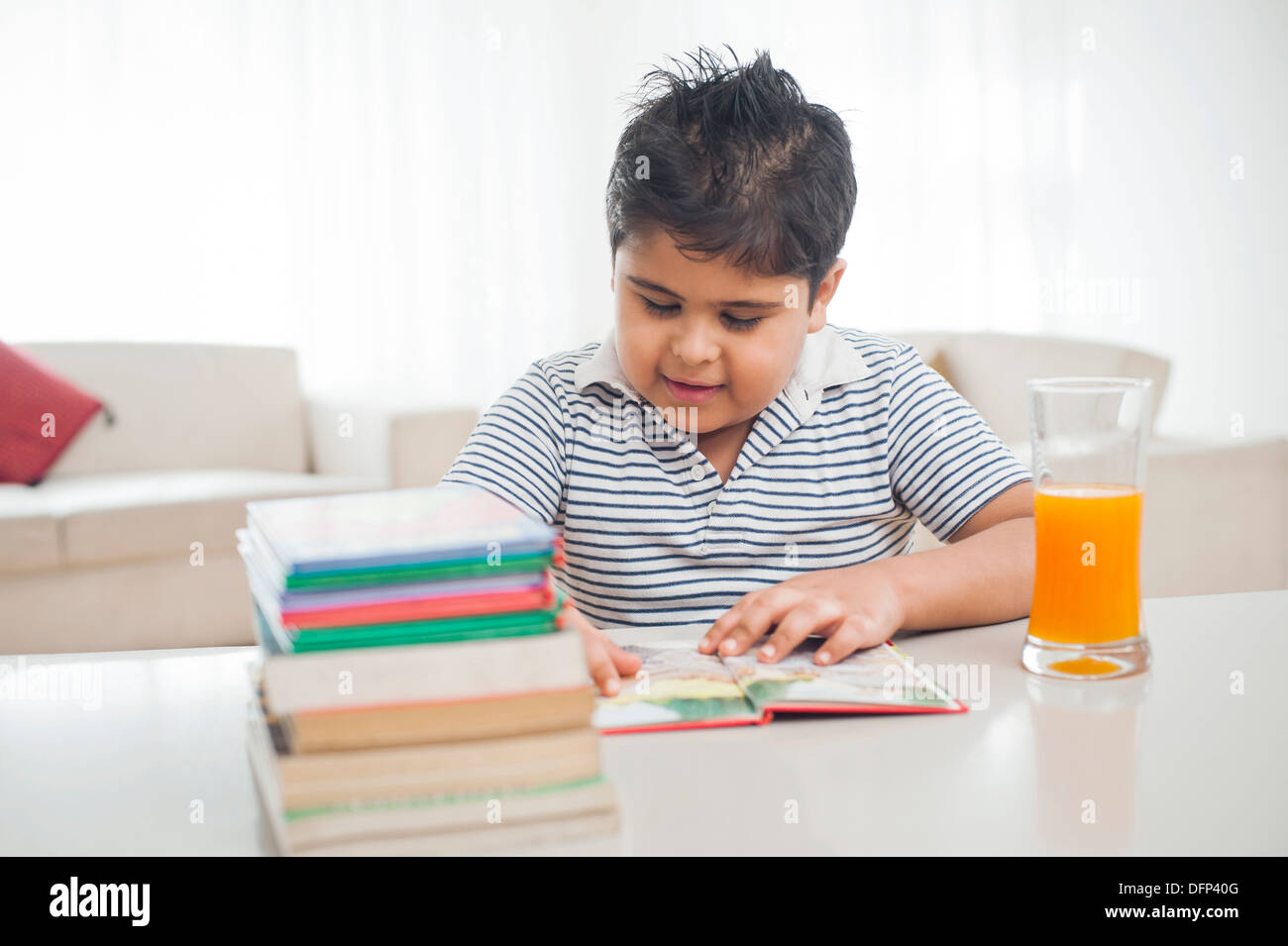Boy reading a book Stock Photo - Alamy