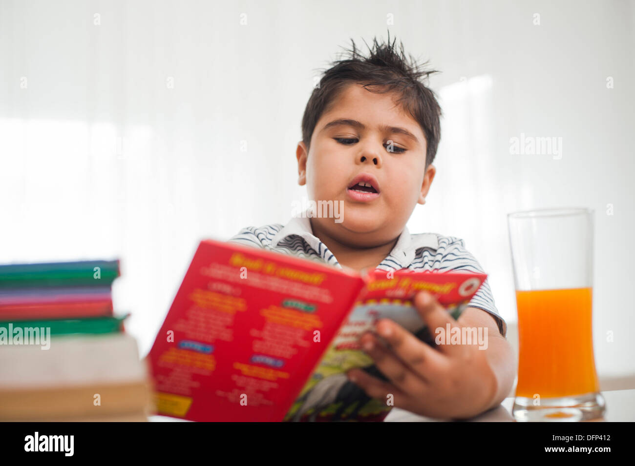 Boy reading a book Stock Photo - Alamy