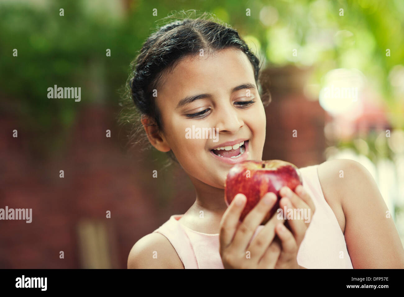 Close-up of a girl eating an apple Stock Photo - Alamy