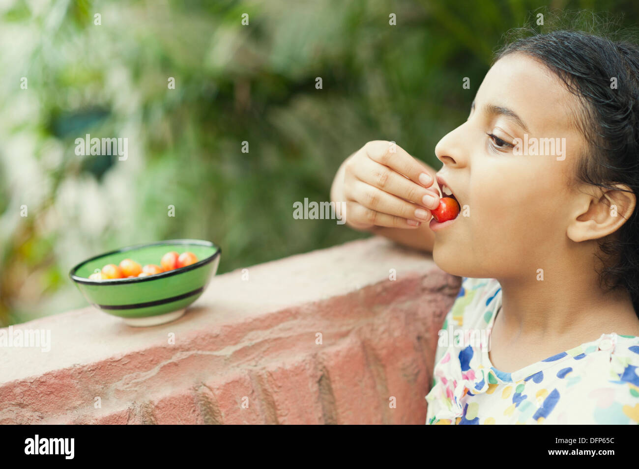 Close-up of a girl eating cherry Stock Photo - Alamy