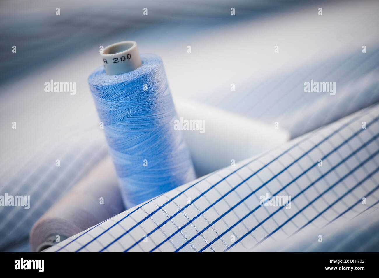 Close-up of spools of thread on a fabric Stock Photo - Alamy