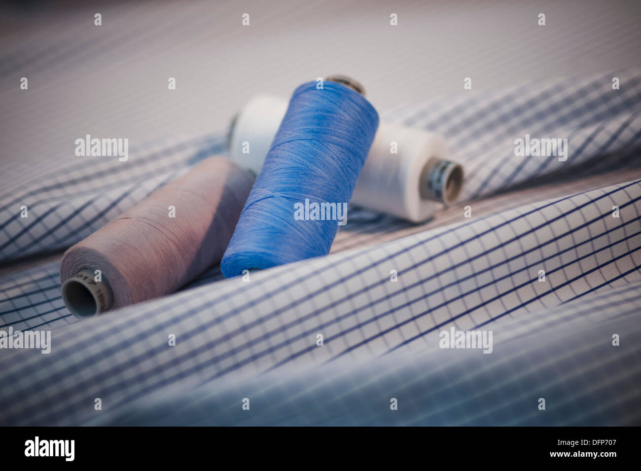Close-up of spools of thread on a fabric Stock Photo - Alamy