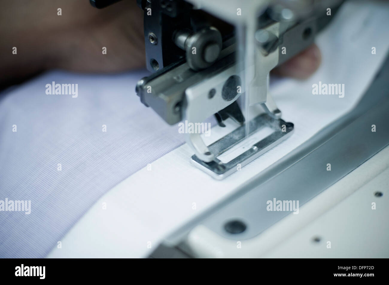 Cloth being stitched on the sewing machine Stock Photo - Alamy