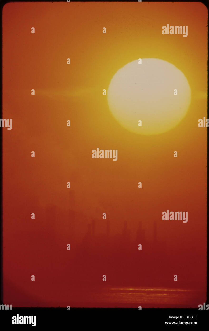 Smog in Cleveland distorts the image of the rising sun, obscuring the ...
