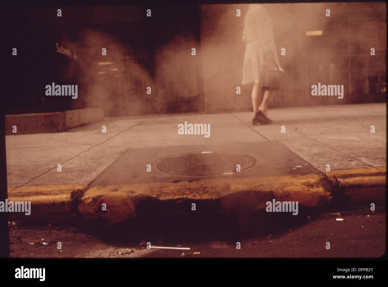 The image depicts steam rising from a sewer, likely due to underground ...