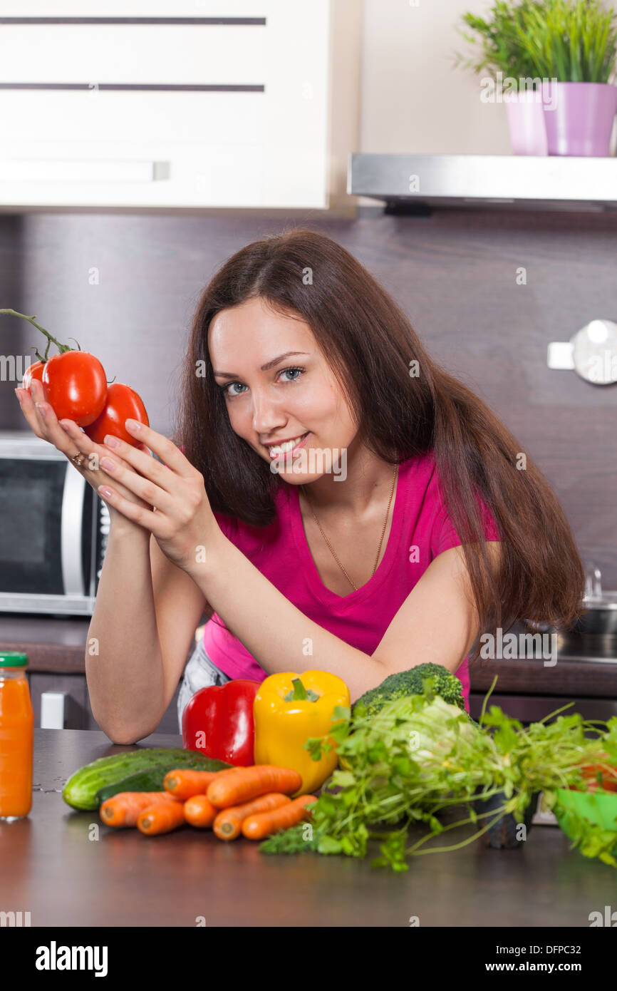 Young woman making salad at domestic kitchen Stock Photo - Alamy