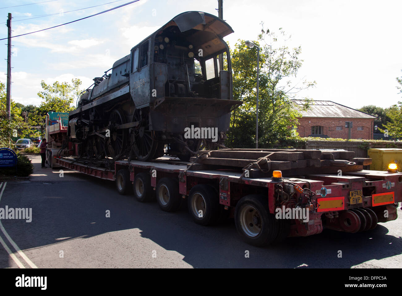 Steam locomotive engine being delivered on the back of a lorry ...