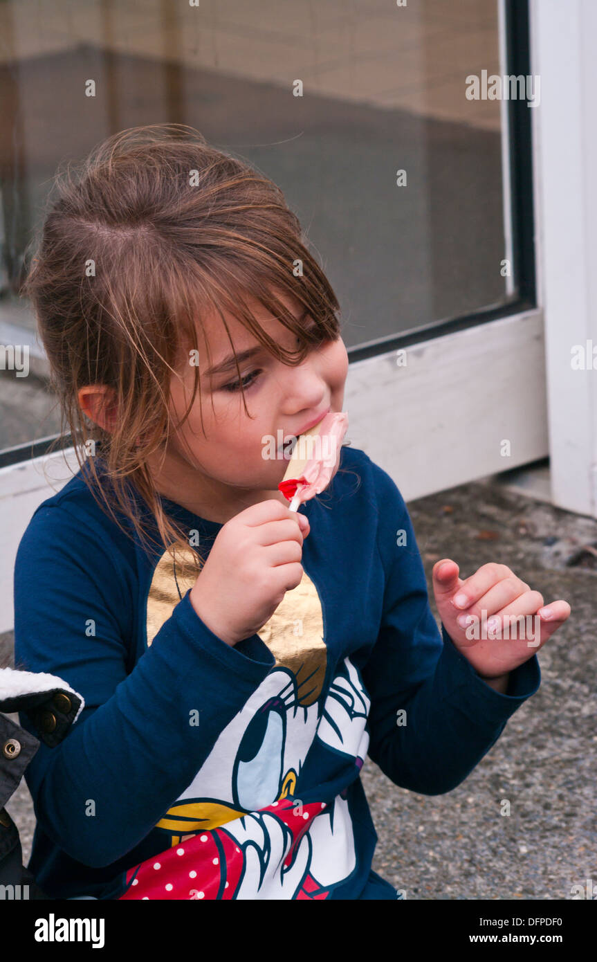 Little Girl Eating a Chewy Sweet Stock Photo - Alamy
