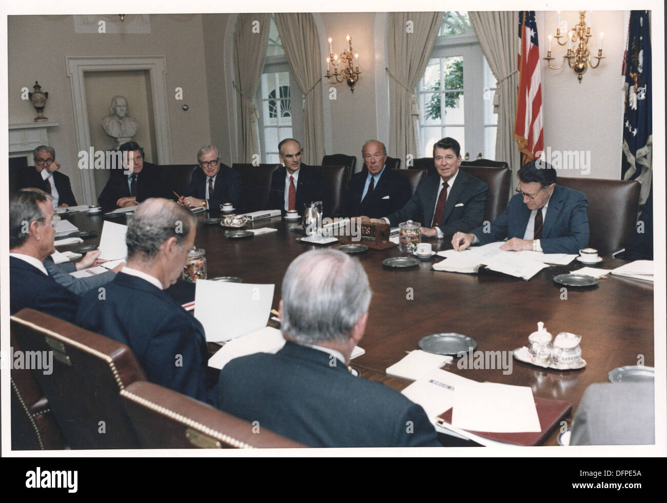 A photograph captures President Ronald Reagan leading a Cabinet meeting ...