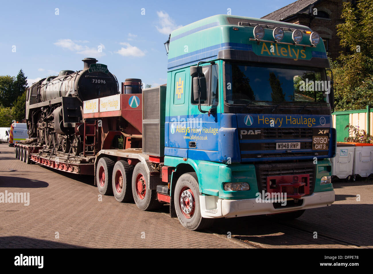 Steam locomotive engine being delivered on the back of a lorry ...