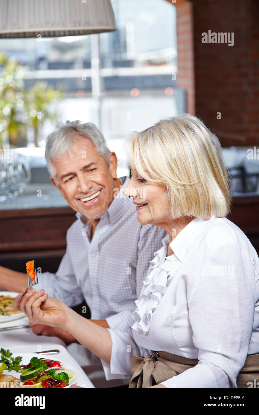Two happy senior citizens eating together in a nursing home Stock Photo ...