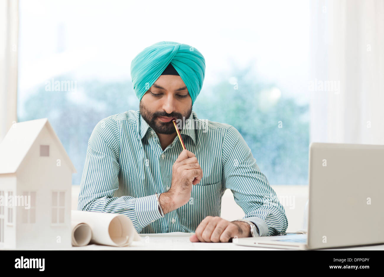 Architect thinking while designing a blueprint Stock Photo - Alamy