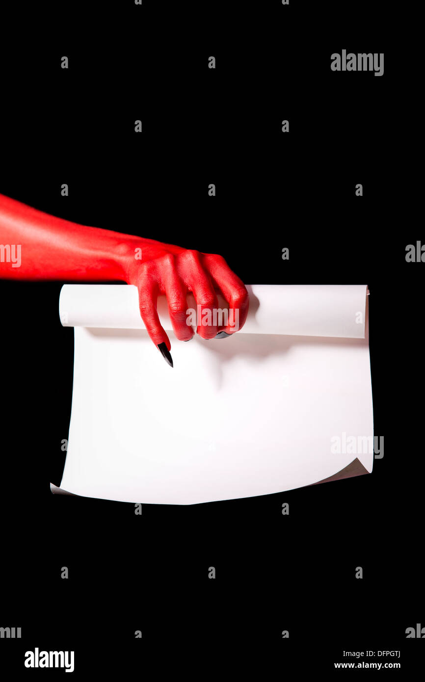 Red devil hand with black nails holding paper scroll, deal with devil ...