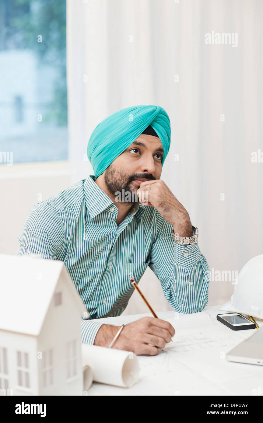 Architect thinking while designing a blueprint Stock Photo - Alamy