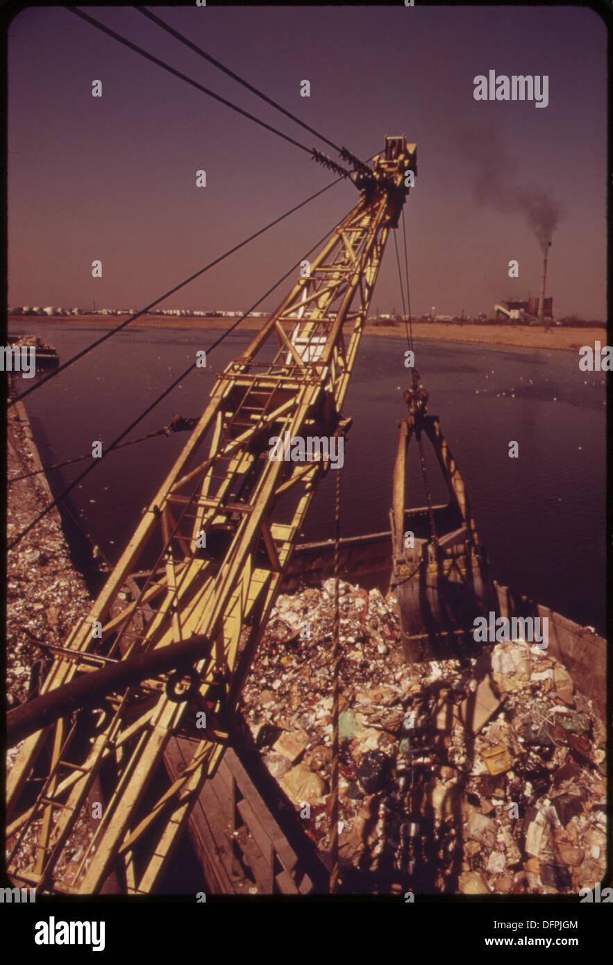 Garbage scows are unloaded at Staten Island, with carts hauling the ...