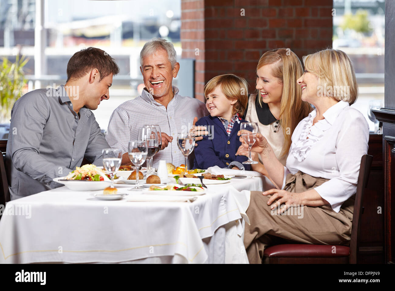Happy family with child smiling together in a restaurant Stock Photo ...