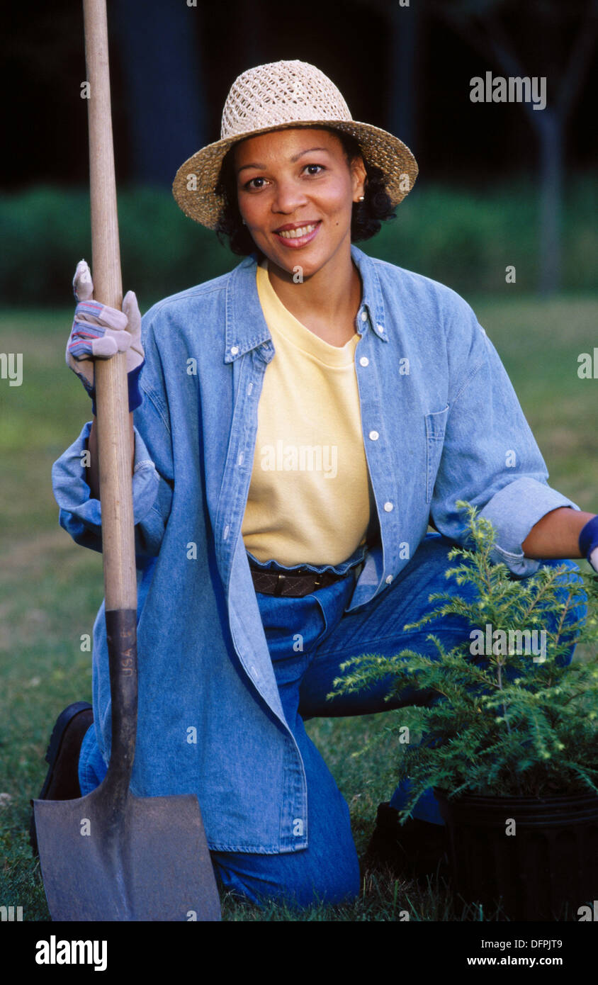 Black woman planting tree hi-res stock photography and images - Alamy