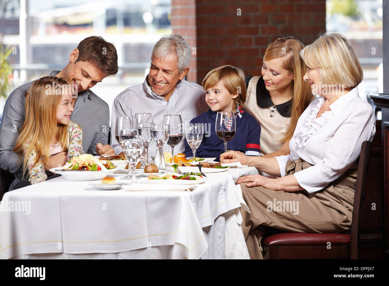 Happy Family Eating At Restaurant