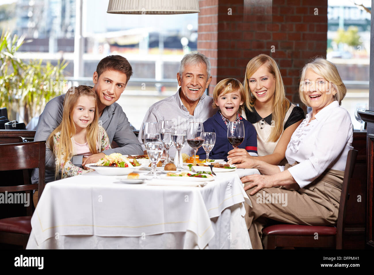 Happy family with children and seniors eating out in a restaurant Stock ...