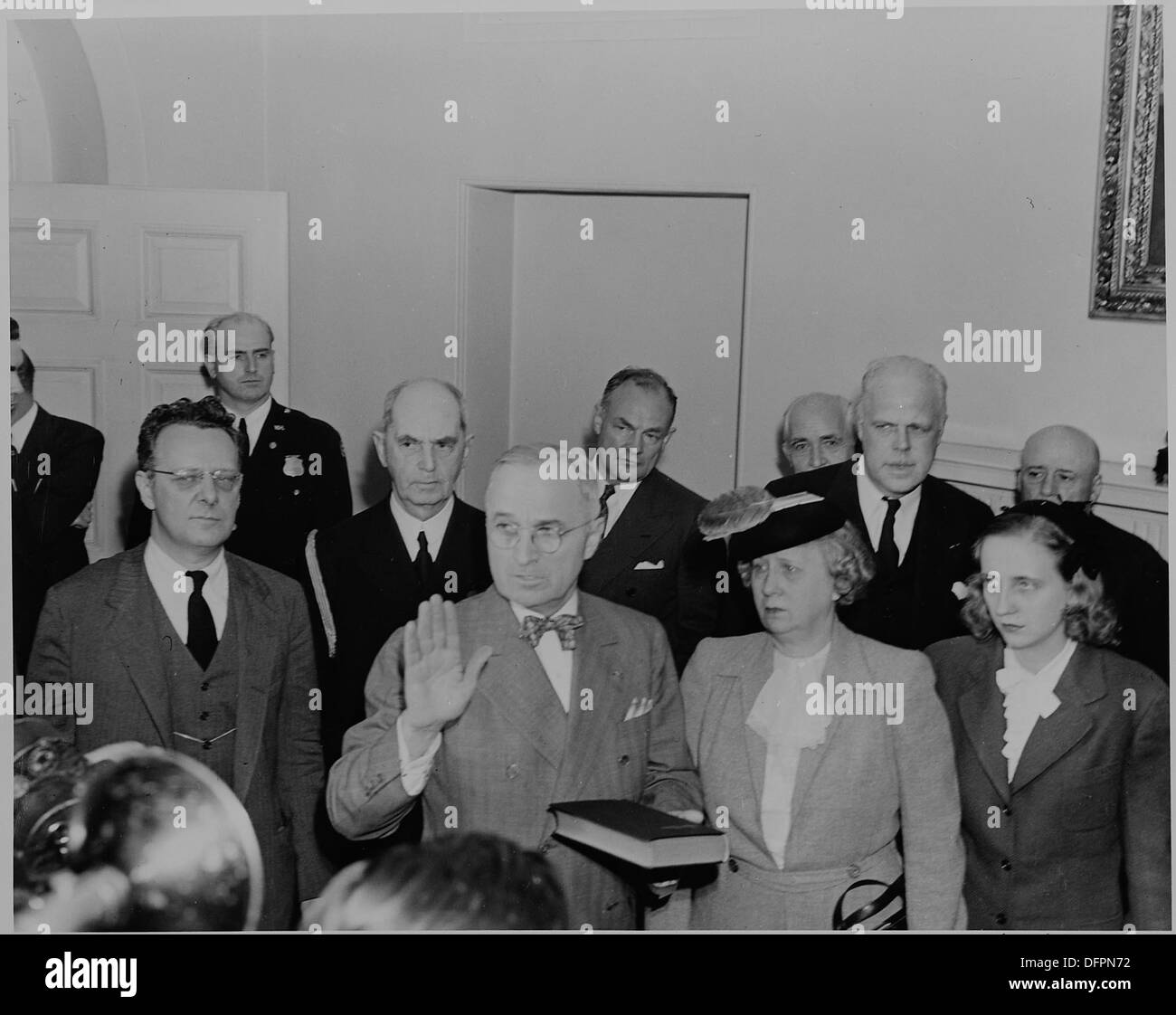 A historic photograph of President Harry S. Truman taking the oath of ...