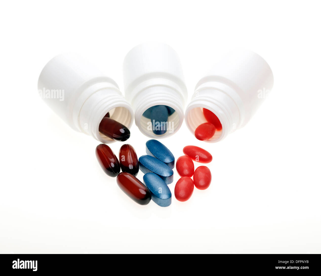 Spilled capsules from white prescription bottles on a white background ...