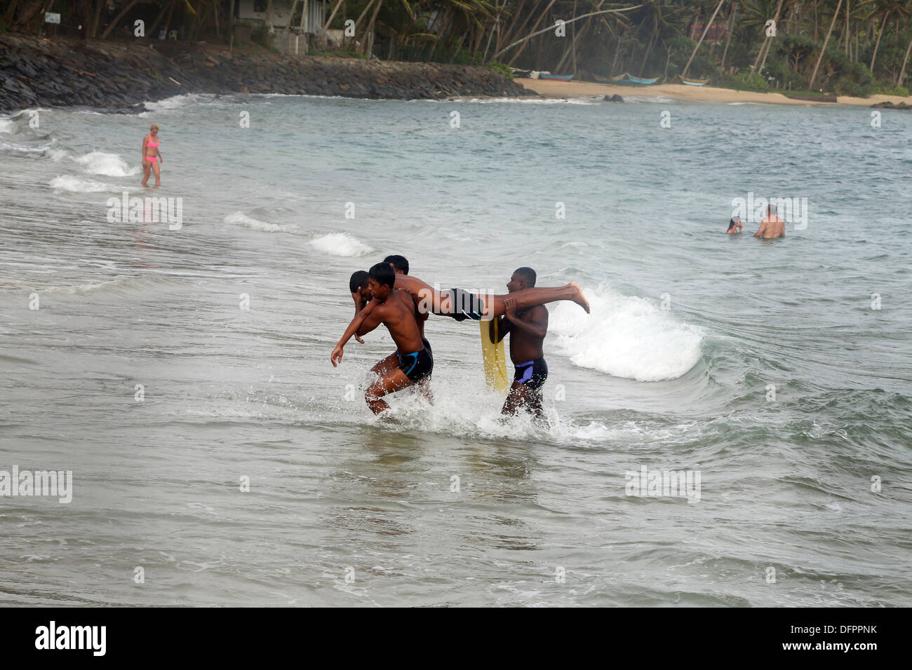 Sri Lankan life guards practice rescuing drowning man on beach at ...
