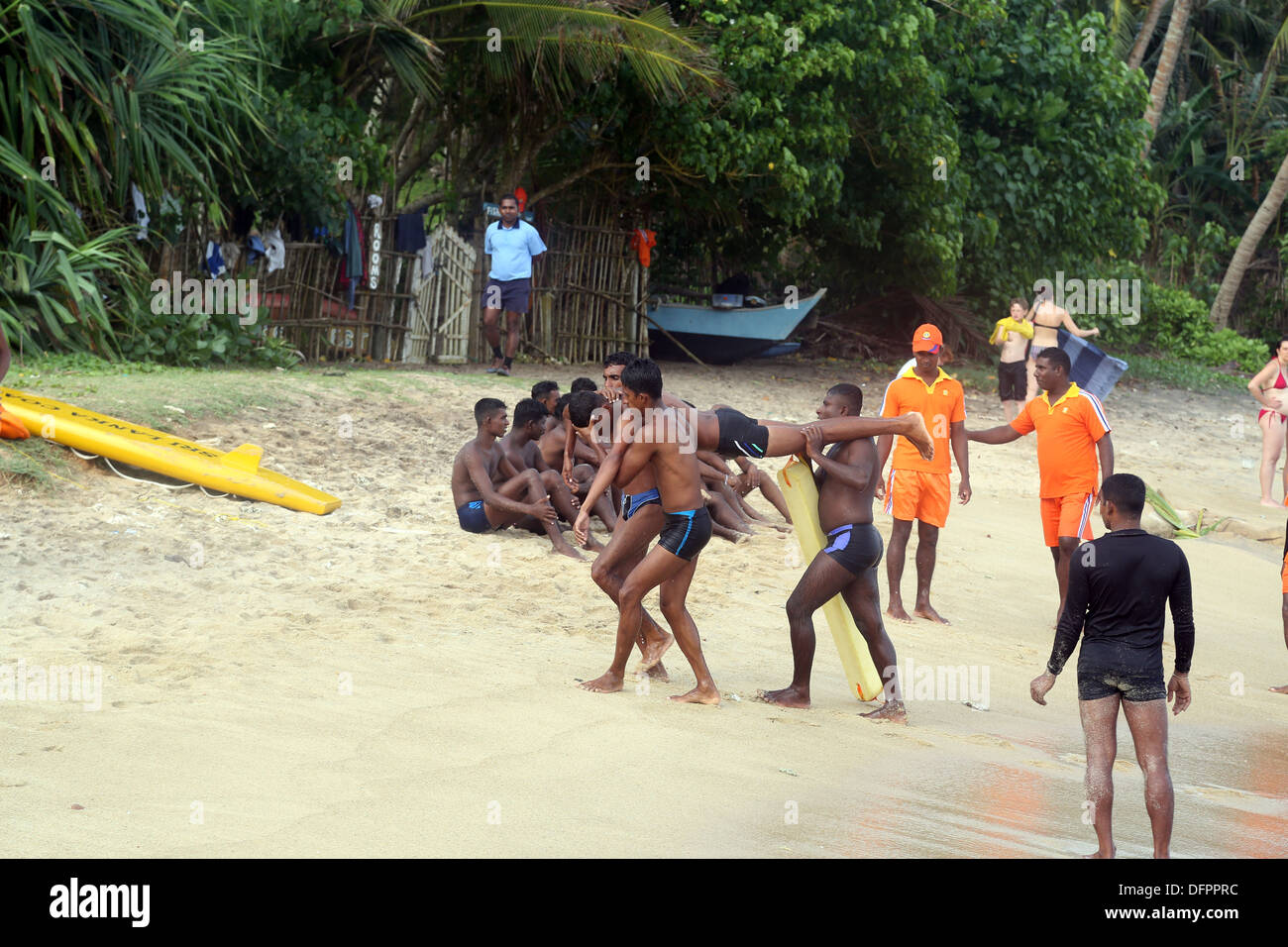 Sri Lankan life guards practice rescuing drowning man on beach at ...