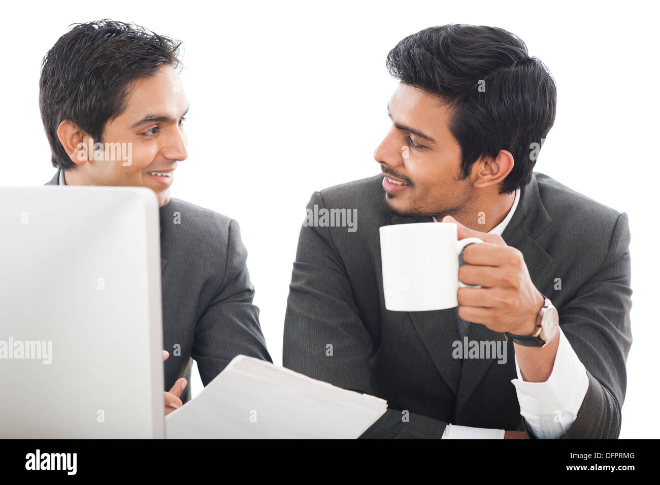 Two smiling businessmen discussing Stock Photo - Alamy