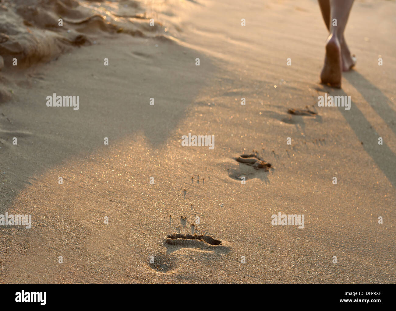 A young woman walking on the sand Stock Photo - Alamy