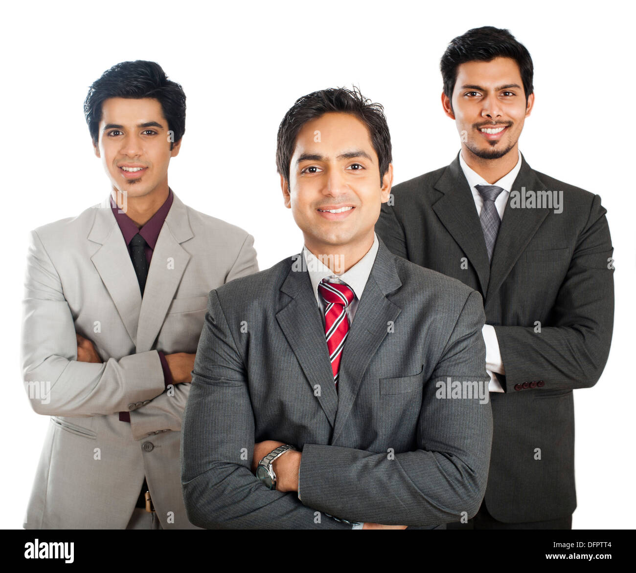 Portrait of three businessmen standing with their arms crossed and ...