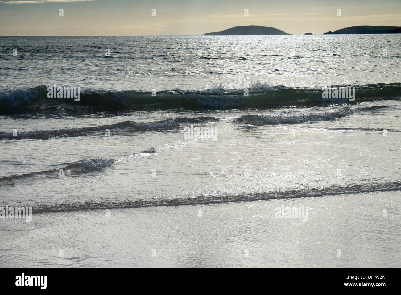 Evening incoming tide with Bardsey island on the horizon Stock Photo ...