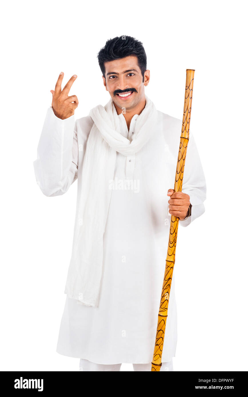Portrait of a man holding a wooden staff and smiling Stock Photo - Alamy
