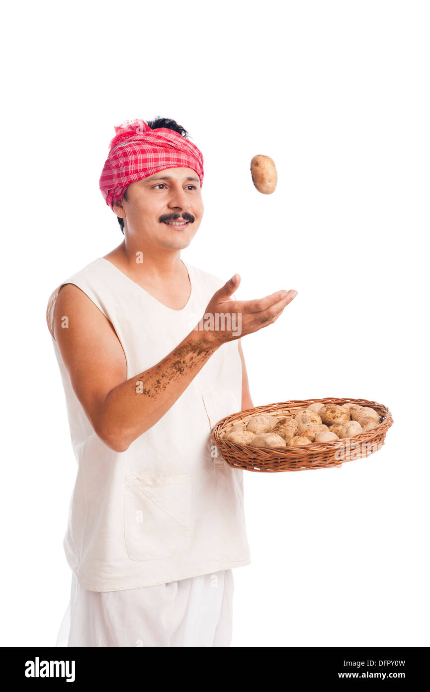 Farmer tossing a potato from the basket Stock Photo - Alamy