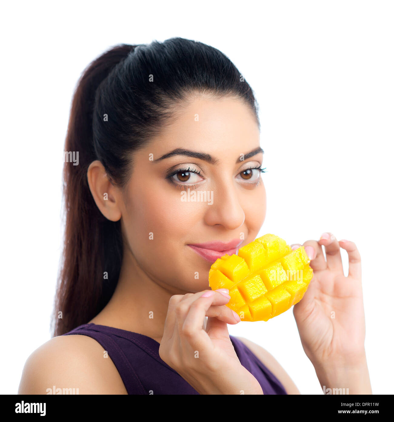 Portrait of a woman eating mango Stock Photo - Alamy