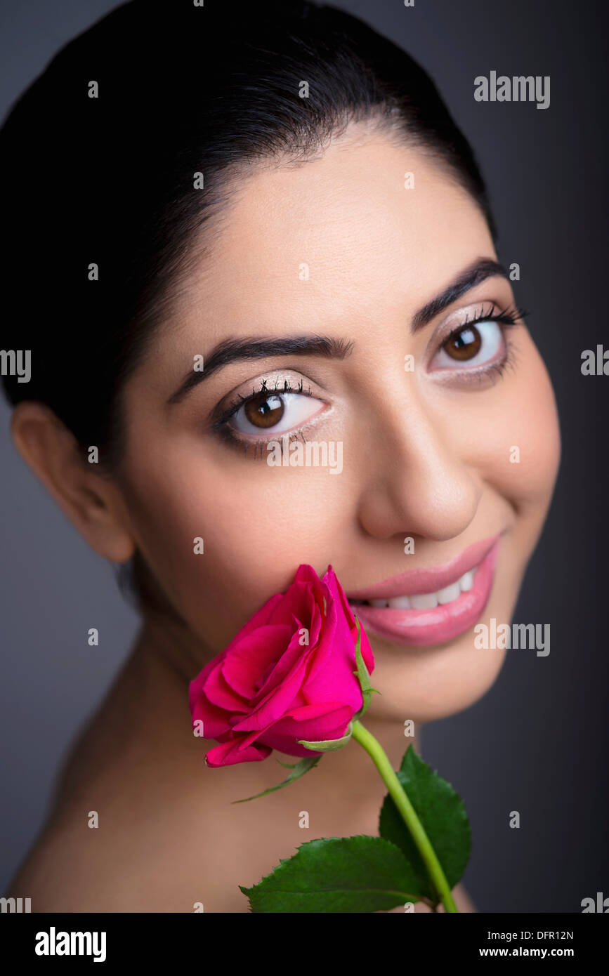 Portrait of a beautiful woman with rose Stock Photo - Alamy