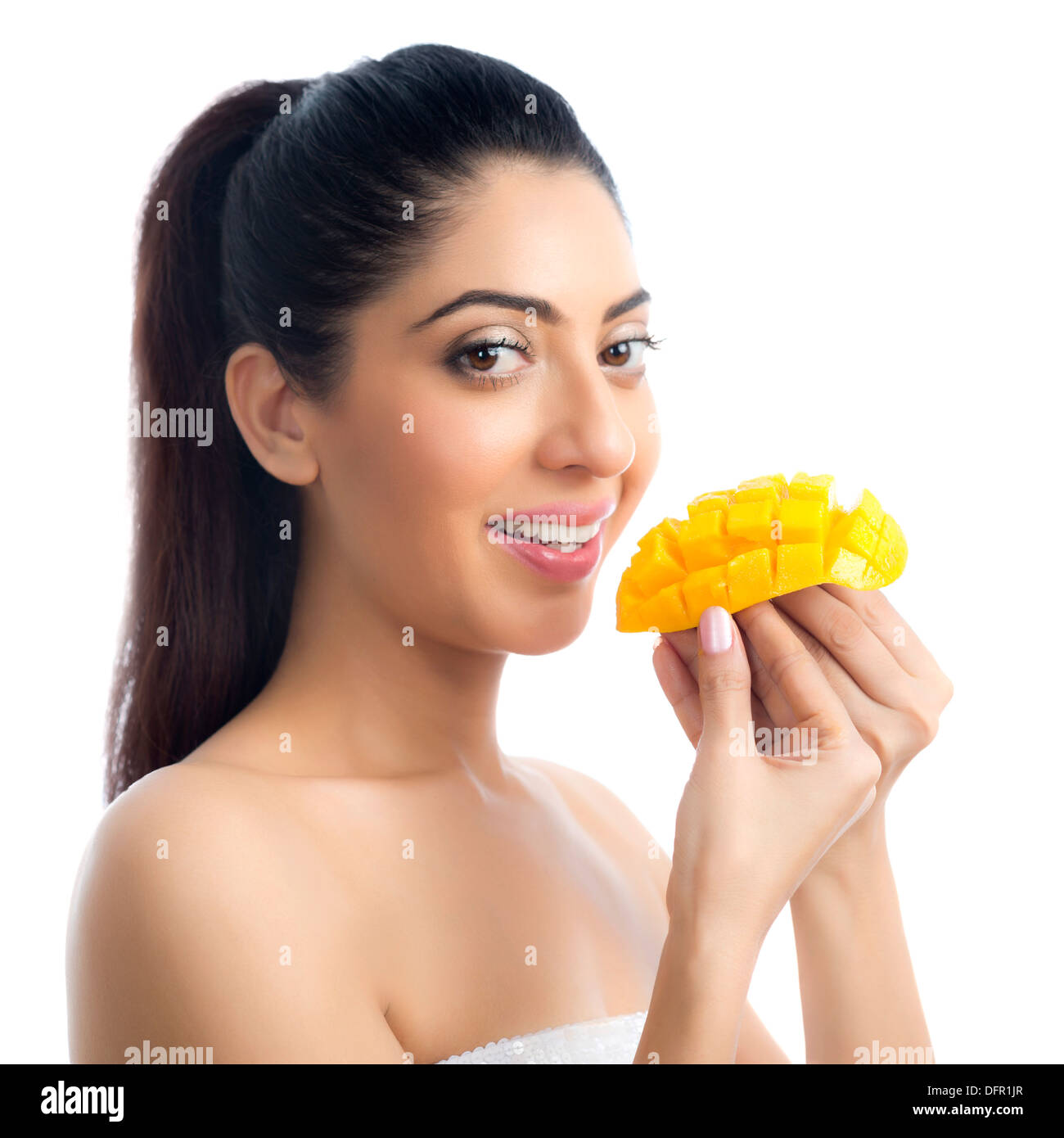 Portrait of a woman eating mango Stock Photo - Alamy