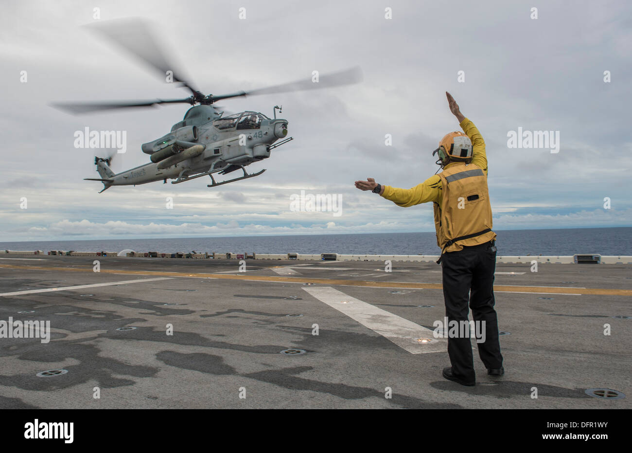 An AH-1Z Super Cobra lands on the flight deck of the amphibious assault ...