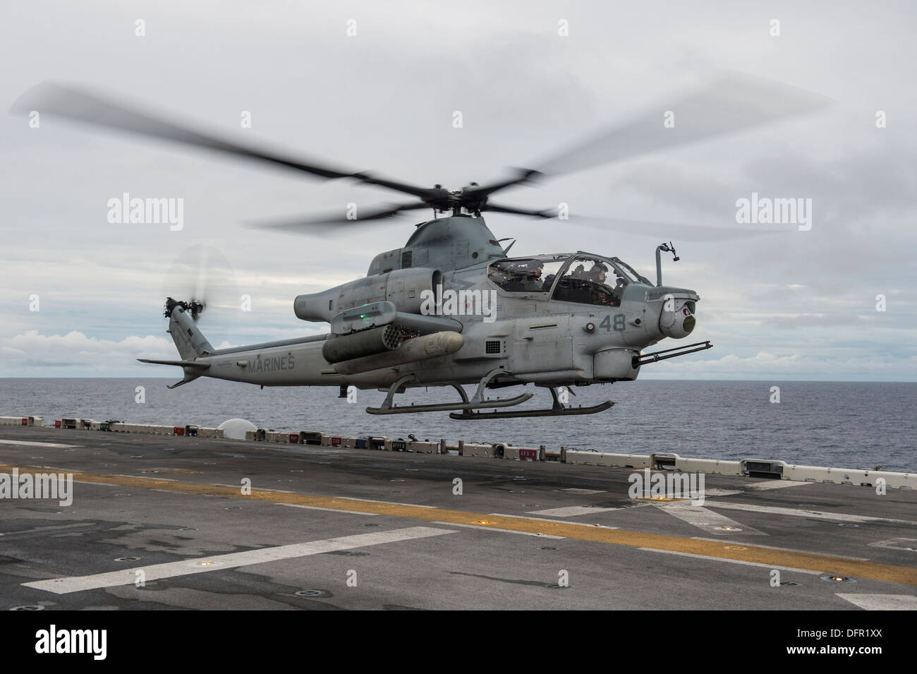 An AH-1Z Super Cobra lands on the flight deck of the amphibious assault ...