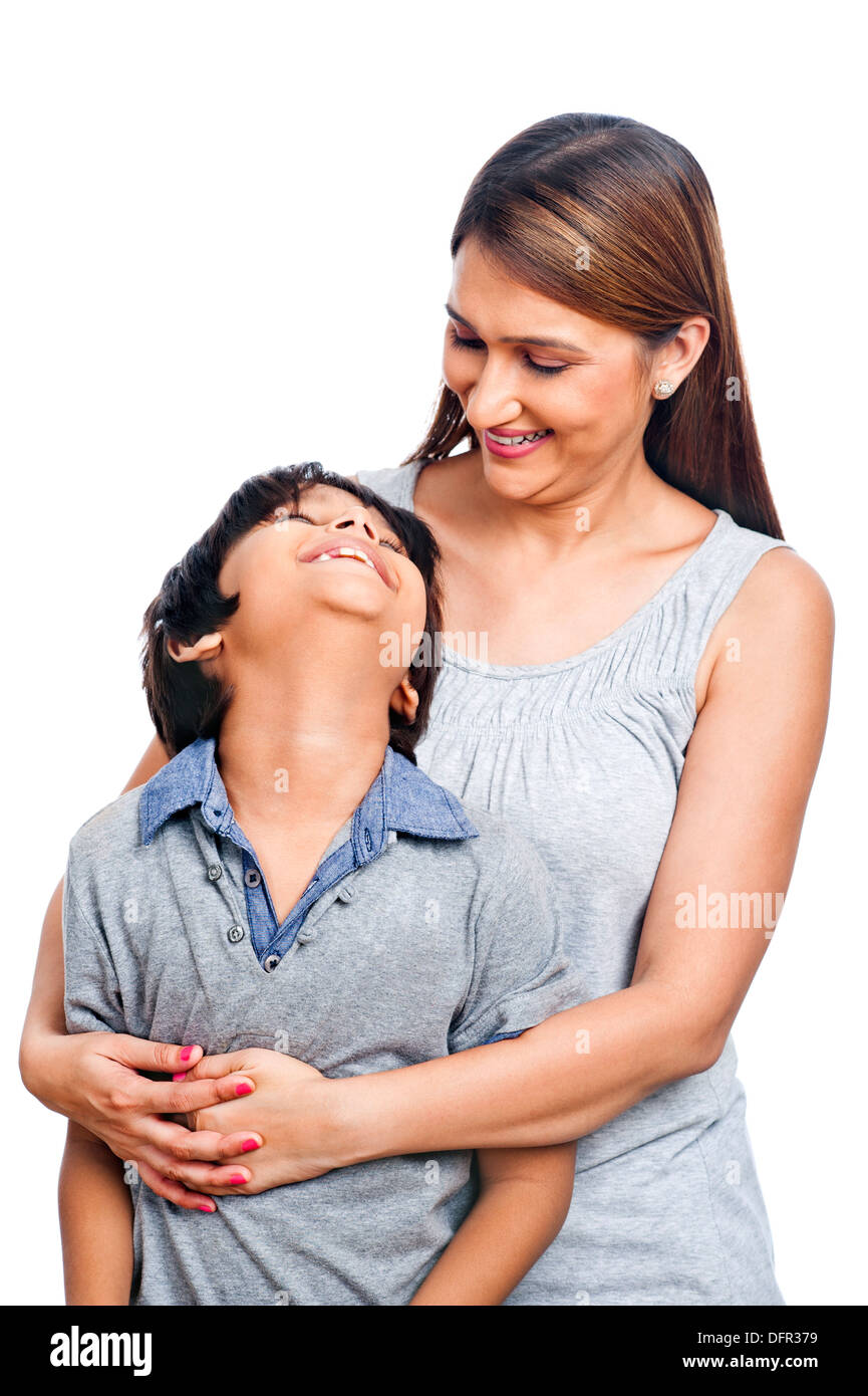 Woman hugging her son from behind and smiling Stock Photo - Alamy