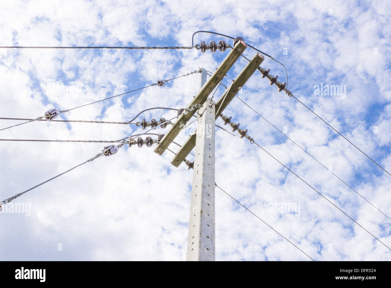 Electricity post in blue sky background Stock Photo - Alamy