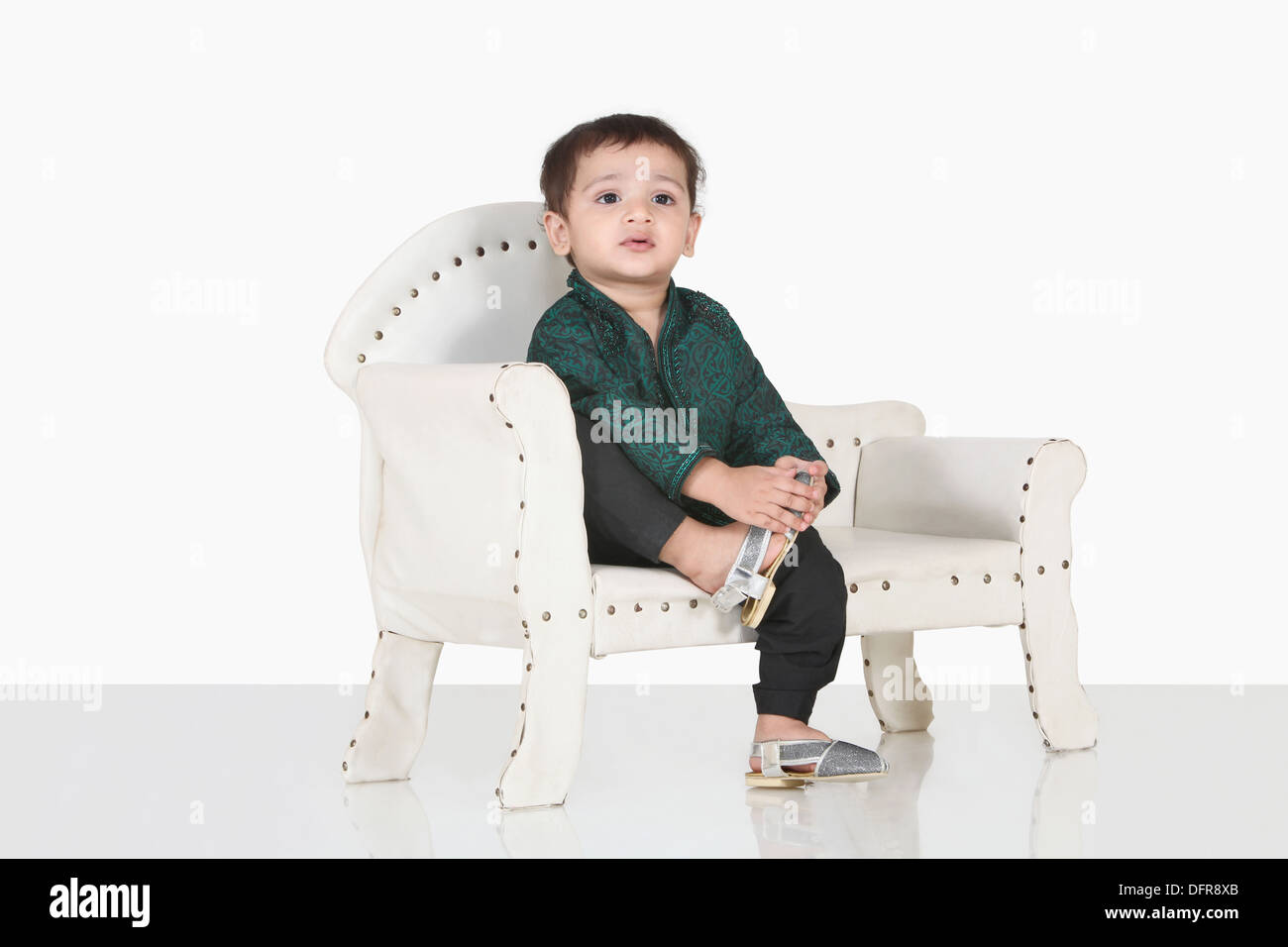 Portrait of a 5 year old indian boy seating on a sofa Stock Photo - Alamy